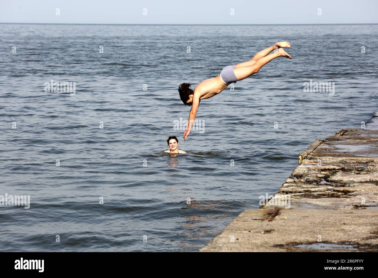 A man dives into the water on Otrada beach. The sea is throwing up more ...