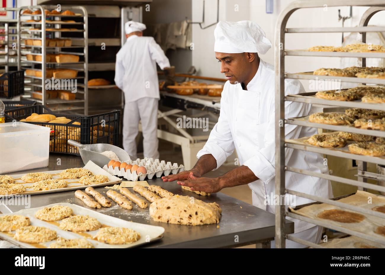 Baker at work - making sweet buns with dough Stock Photo - Alamy