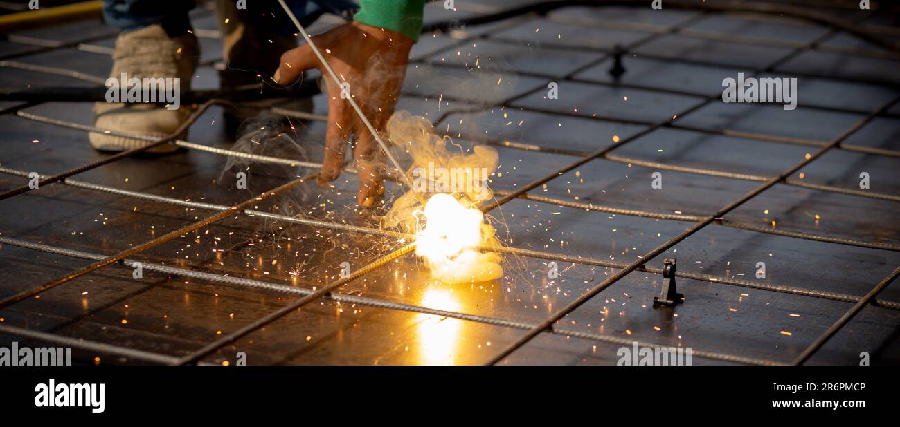 Closeup hands young worker using machine welding iron with hands ...