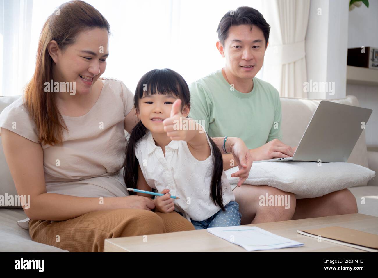 Happy family with mother teaching homework with daughter and father ...