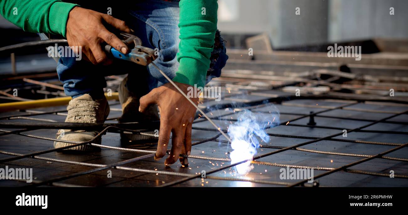 Closeup hands young worker using machine welding iron with hands ...