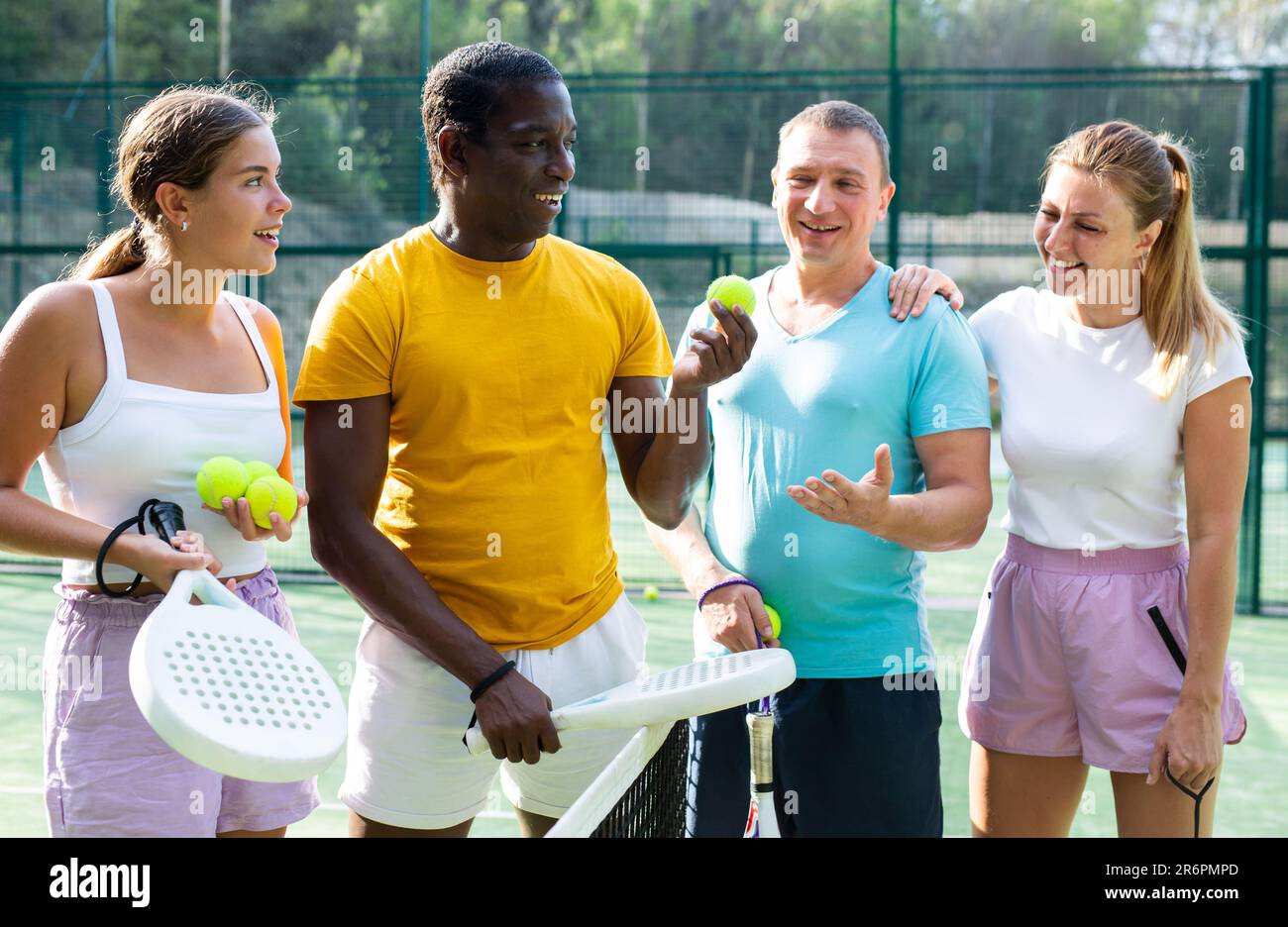 Group photo of positive people on padel tennis court Stock Photo - Alamy