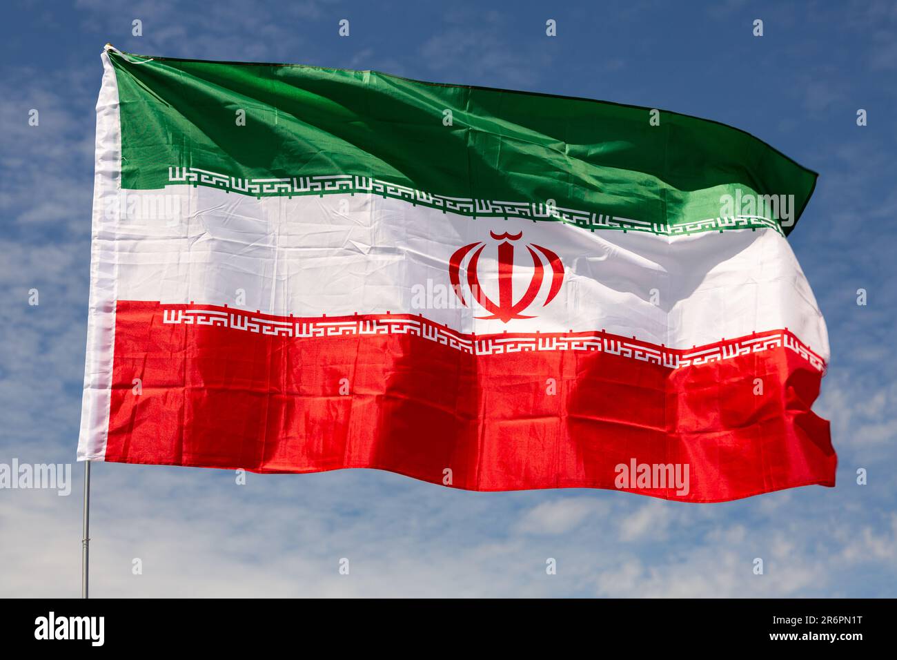 Flag of Iran waving on cloudy sky during daytime Stock Photo - Alamy