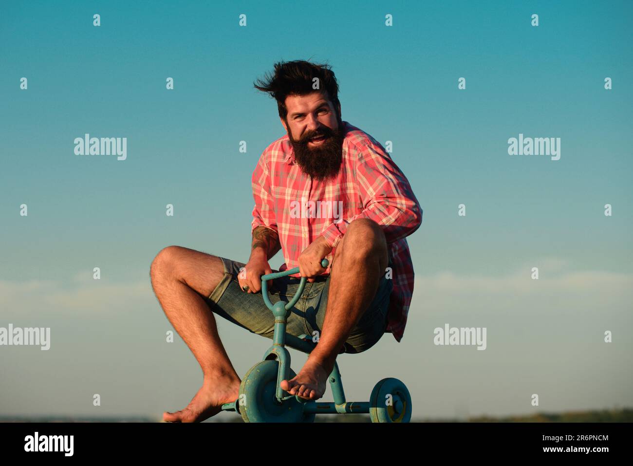 Crazy man bicyclist riding three wheeled bicycle Stock Photo - Alamy