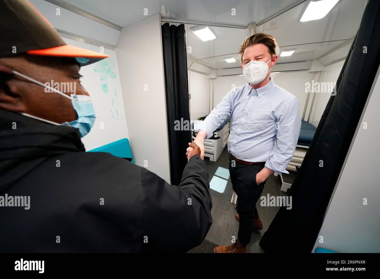 Nurse practitioner Bobby Harris, right, shakes hands with patient ...