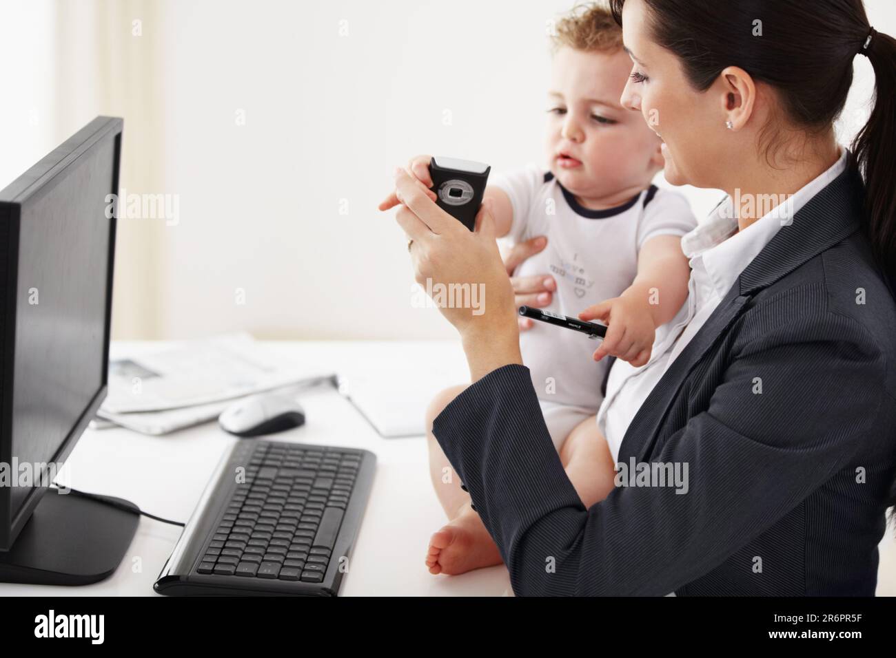 Woman, home office and phone with baby, computer and care with smile ...