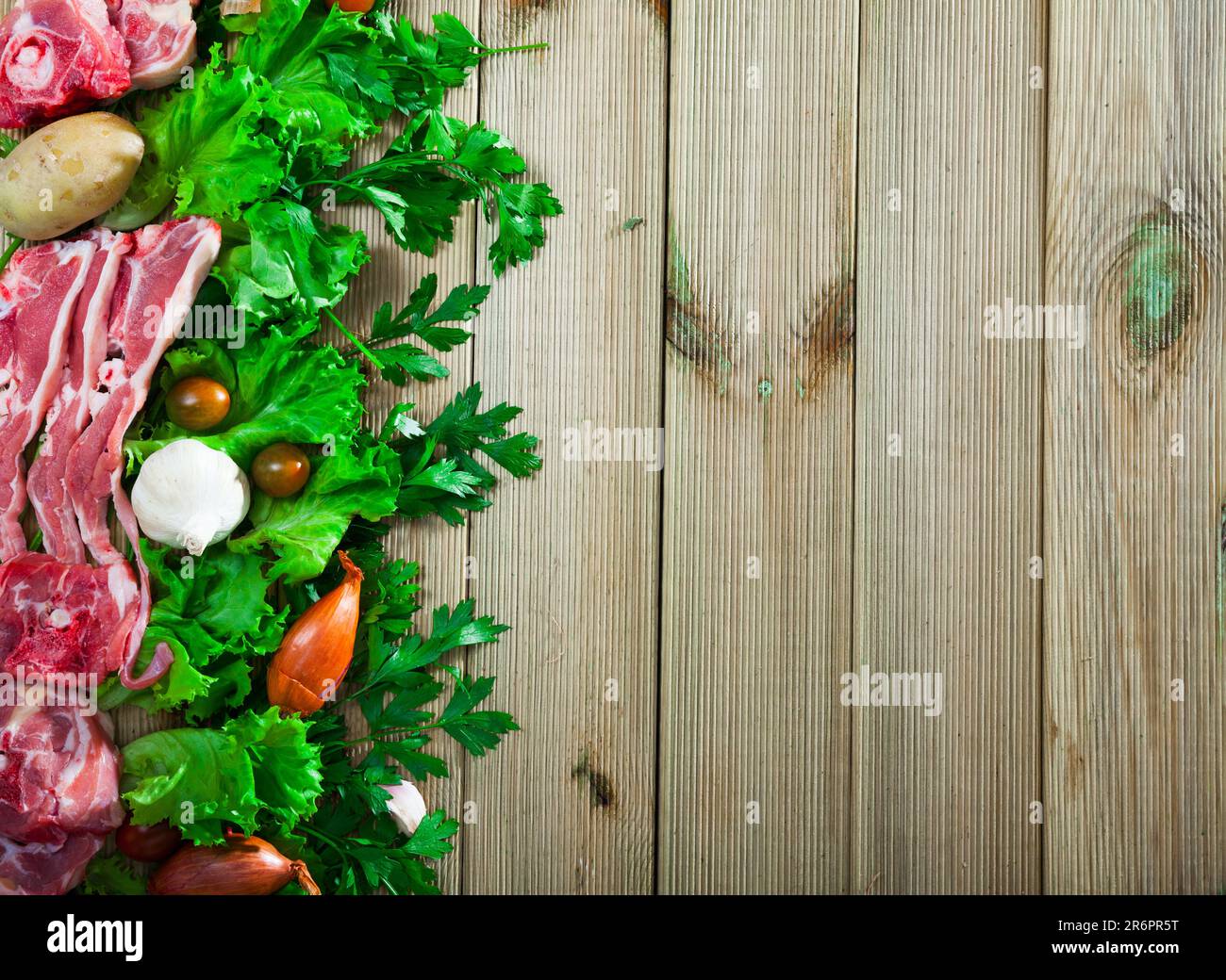 Natural border with lamb and greens Stock Photo - Alamy