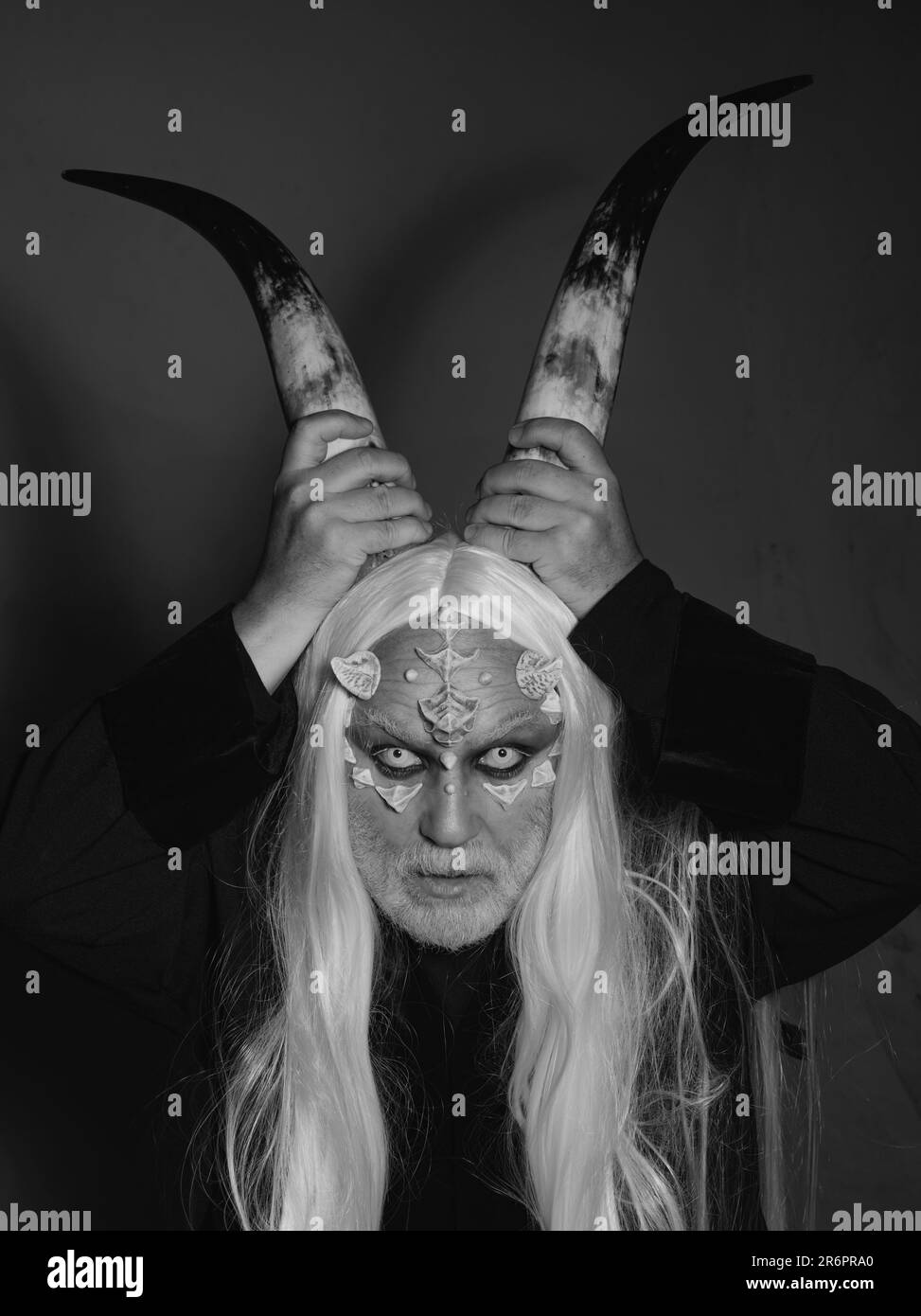 Demon with bloody horns on head. Monster with sharp thorns and warts on ...