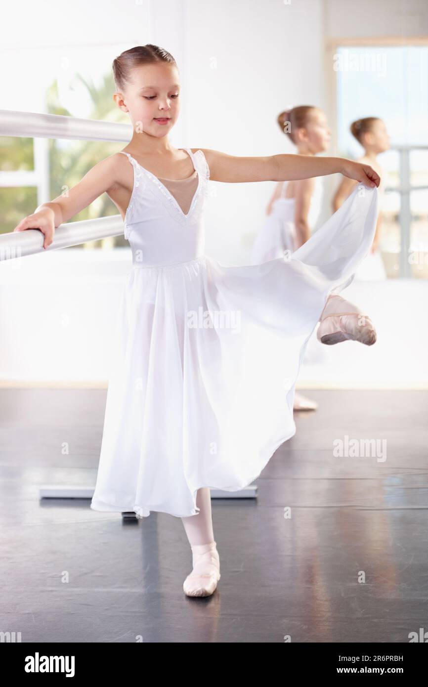 Young girl, ballet training with dancer at academy, ballerina at ...