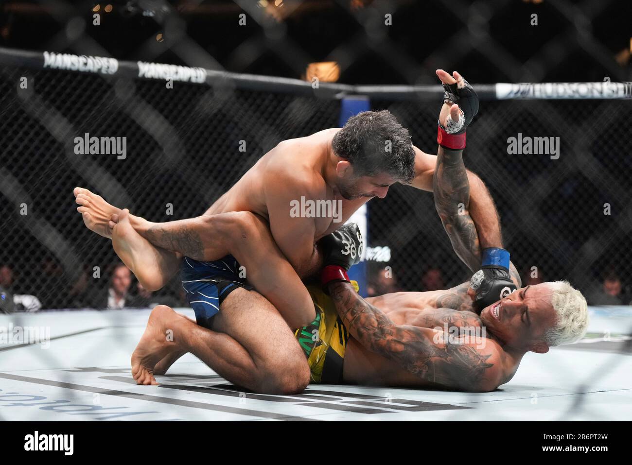 Charles Oliveira, bottom right, and Beneil Dariush fight during a ...