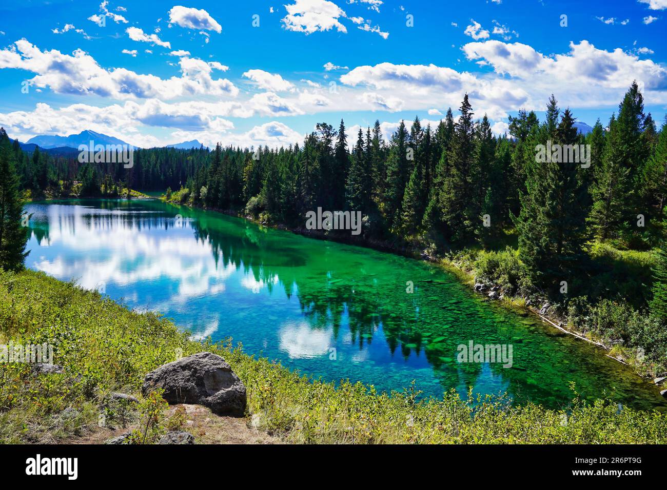 Clouds scud across a bright blue sky over the magnificient azure lakes ...