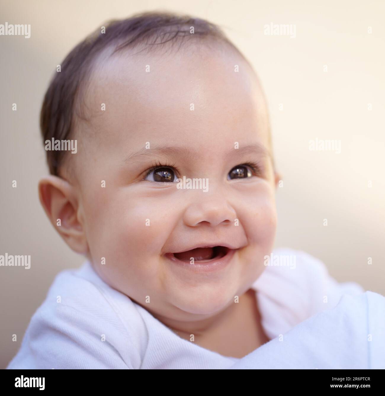 Happy, closeup face of a baby with a smile and health wellness for ...