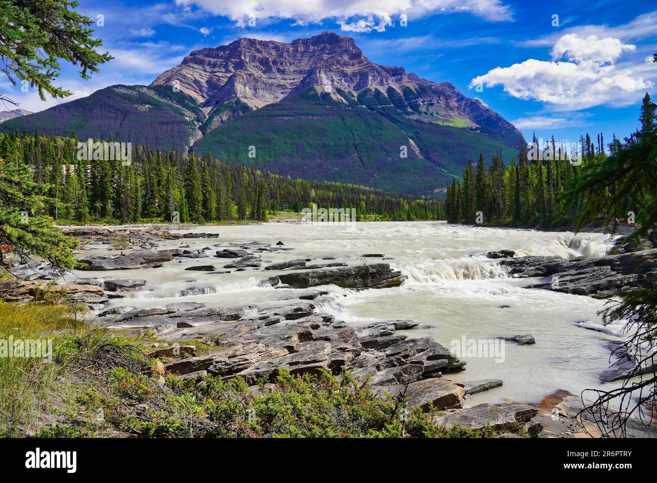 Mount Edith Cavell at 3363 meters towers above the churning waters of ...