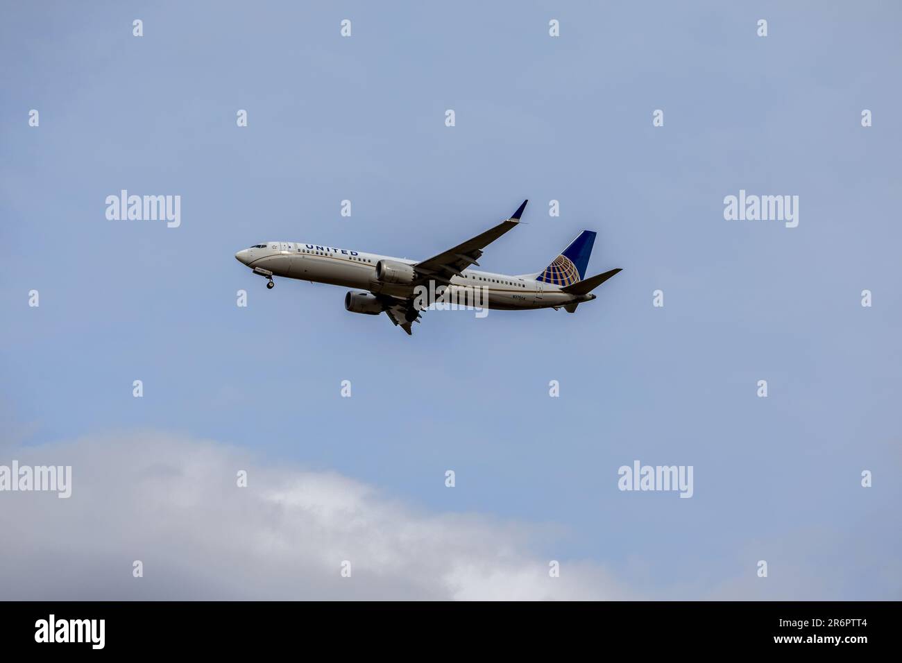 Aurora, Colorado - April 24, 2023: Flying plane against the blue cloudy ...
