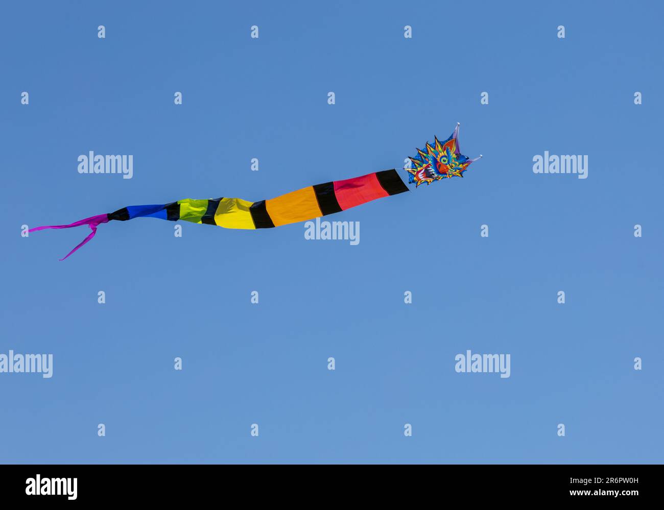 A colorful kite floating in the sky. A kite with blue sky background ...
