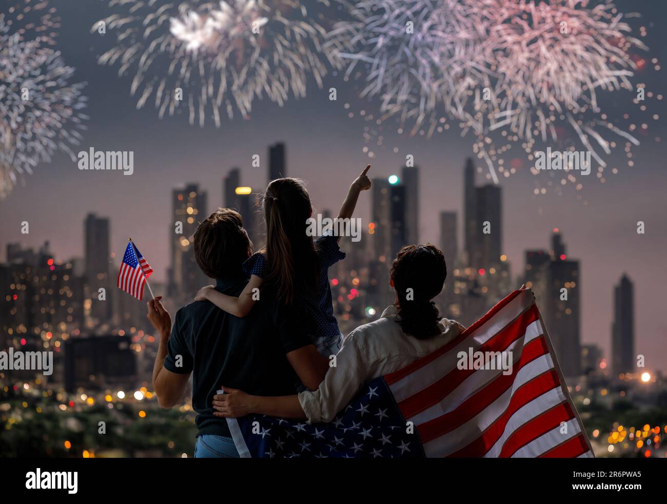 Patriotic holiday. Happy family, father, mother and daughter child girl ...