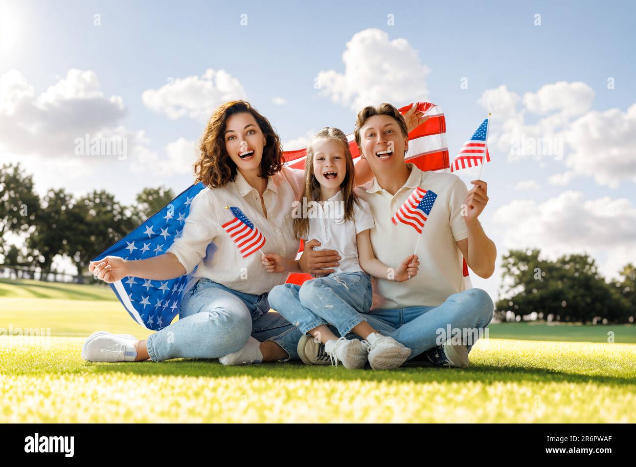 Patriotic holiday. Happy family, parents and daughter child girl with ...