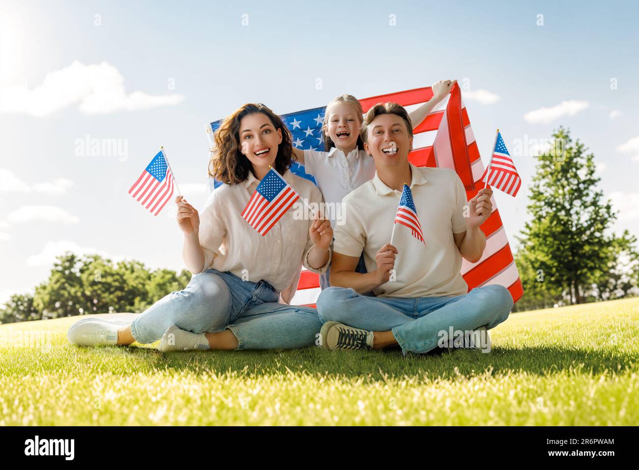 Patriotic holiday. Happy family, parents and daughter child girl with ...