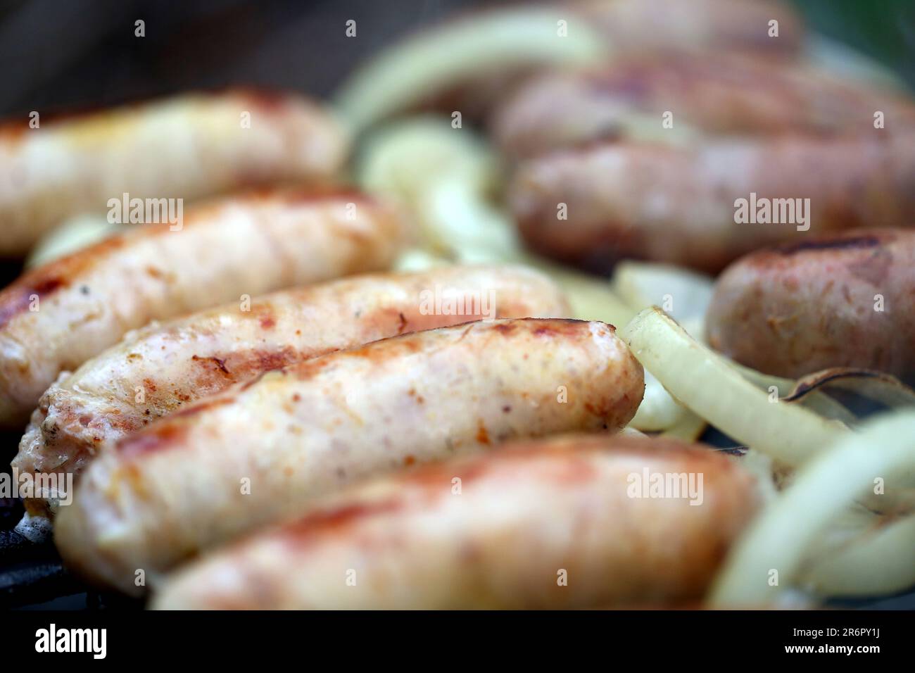 BBQ a lot of sausages with onion general background Stock Photo - Alamy