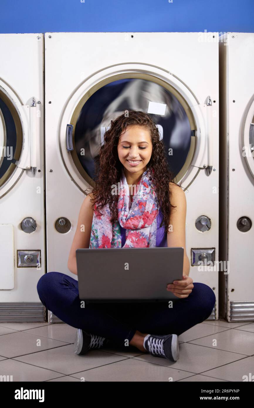 Happy, working and a woman with a laptop at a laundromat for college ...