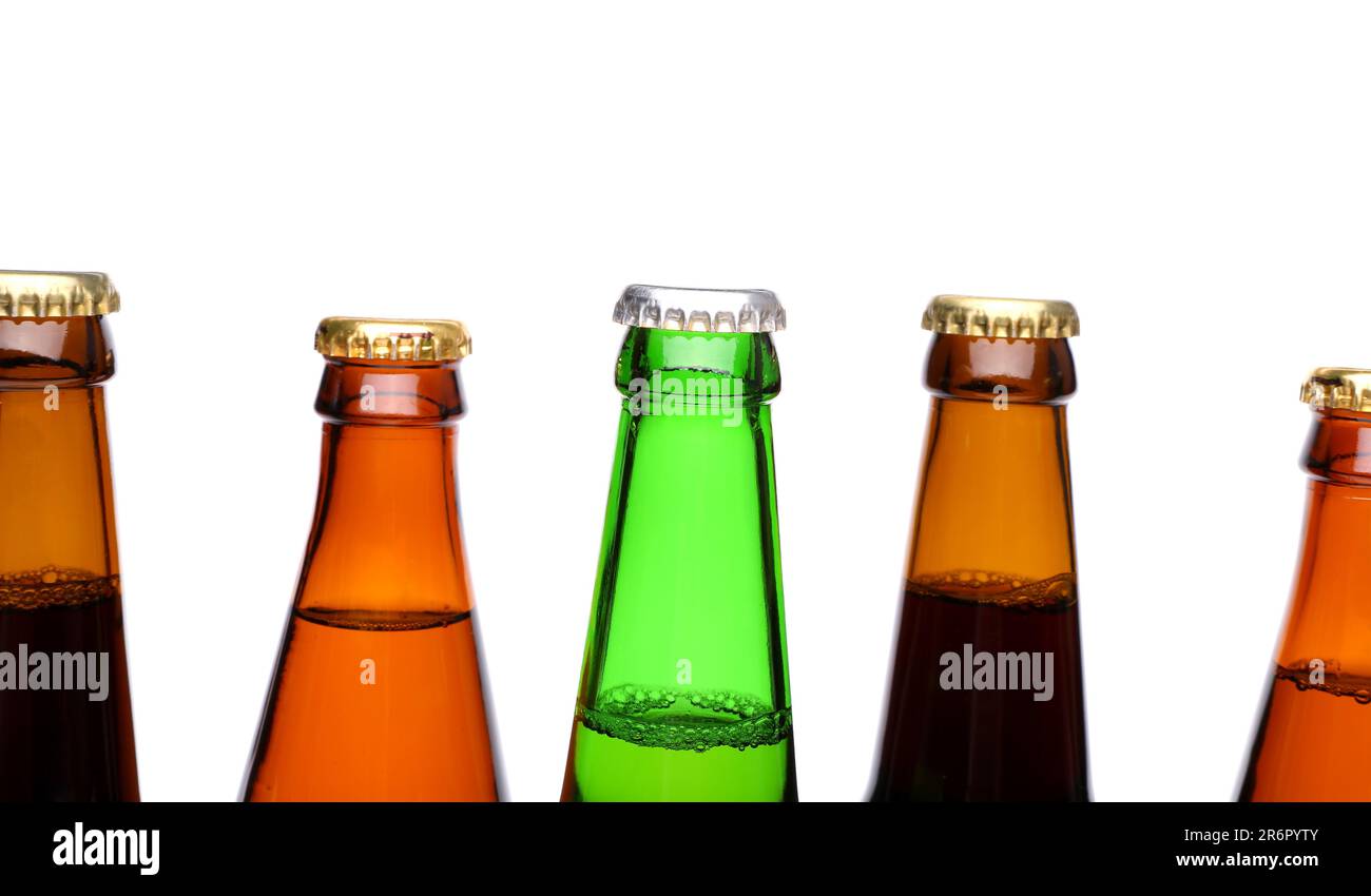 A row of top beer bottlenecks on a white background with a reflection ...