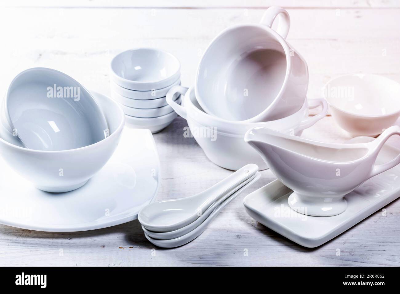 Group of white ceramic plates on a white background, ready to be used ...