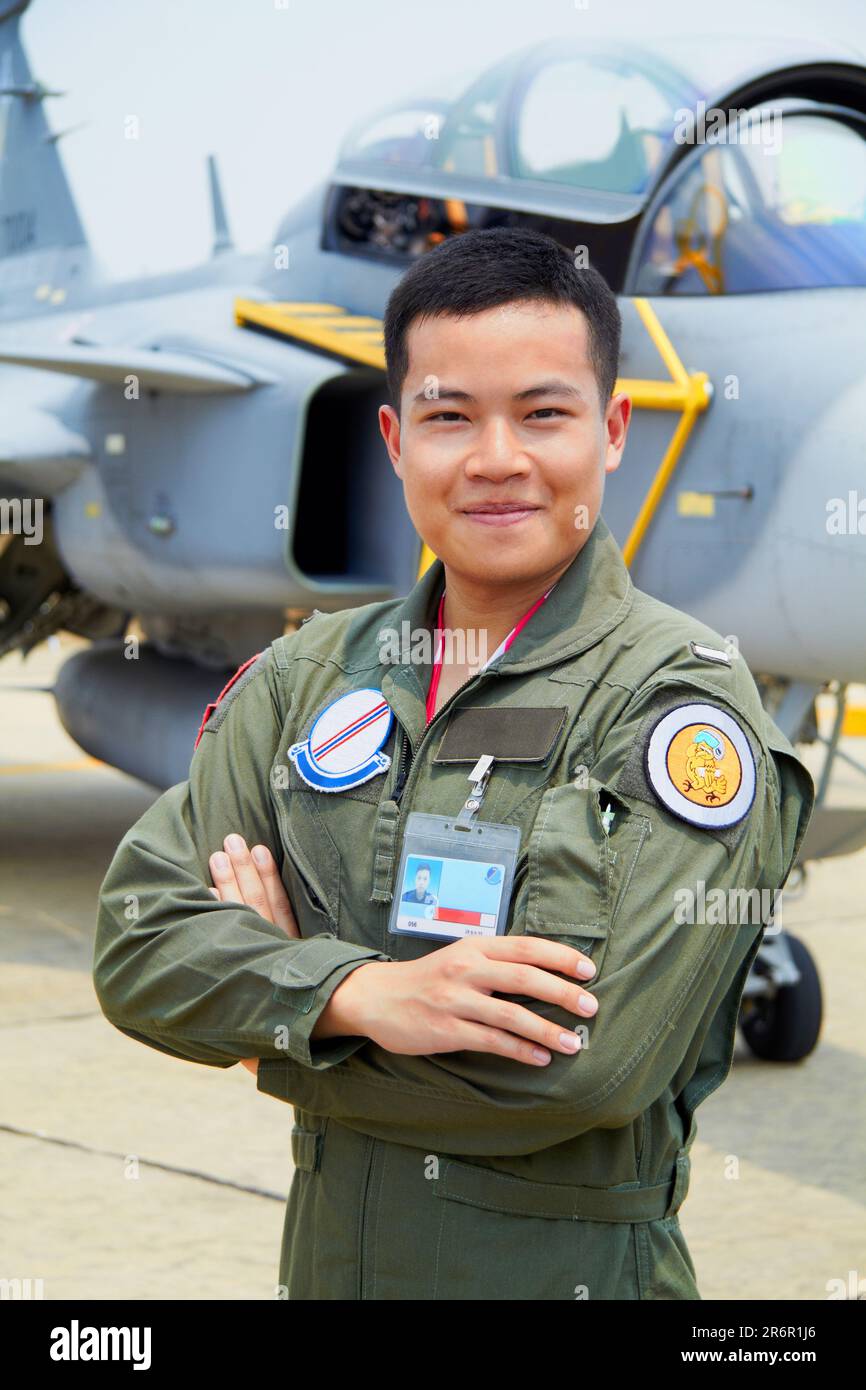 Portrait of man, pilot in military with jet and confident smile at ...