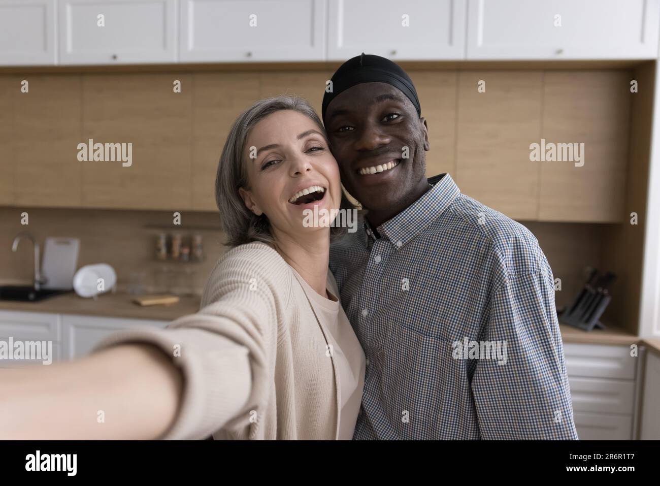 Happy Multiethnic African And Caucasian Couple Taking Selfies At Home