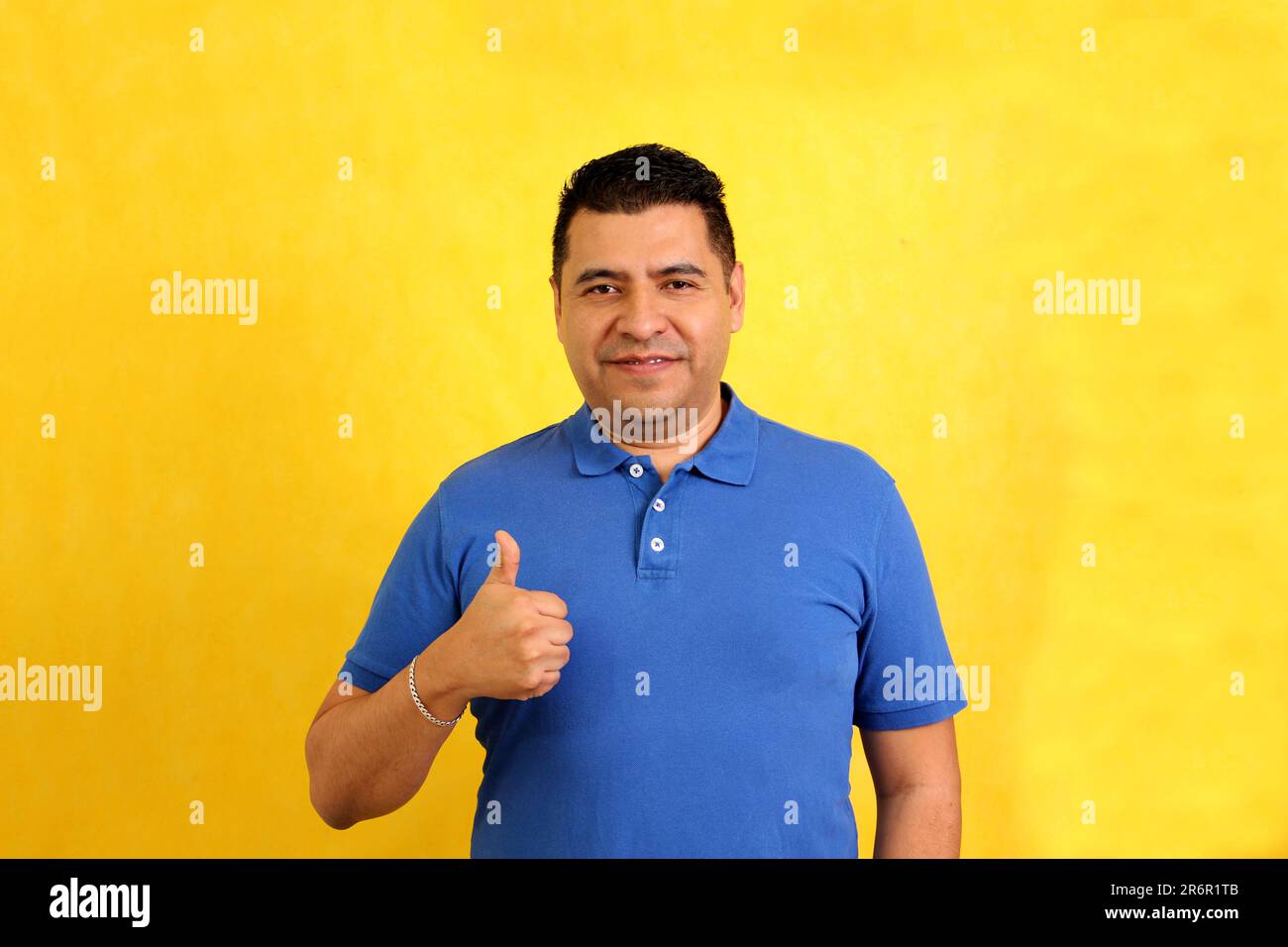 Dark-haired 40-year-old Latino man shows Mexican sign language used to ...