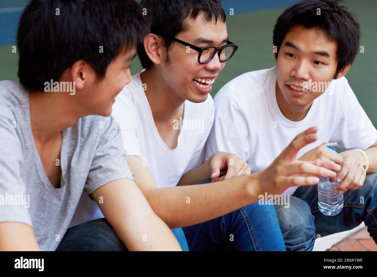 Smile, talking and a group of asian friends sitting outdoor on ...