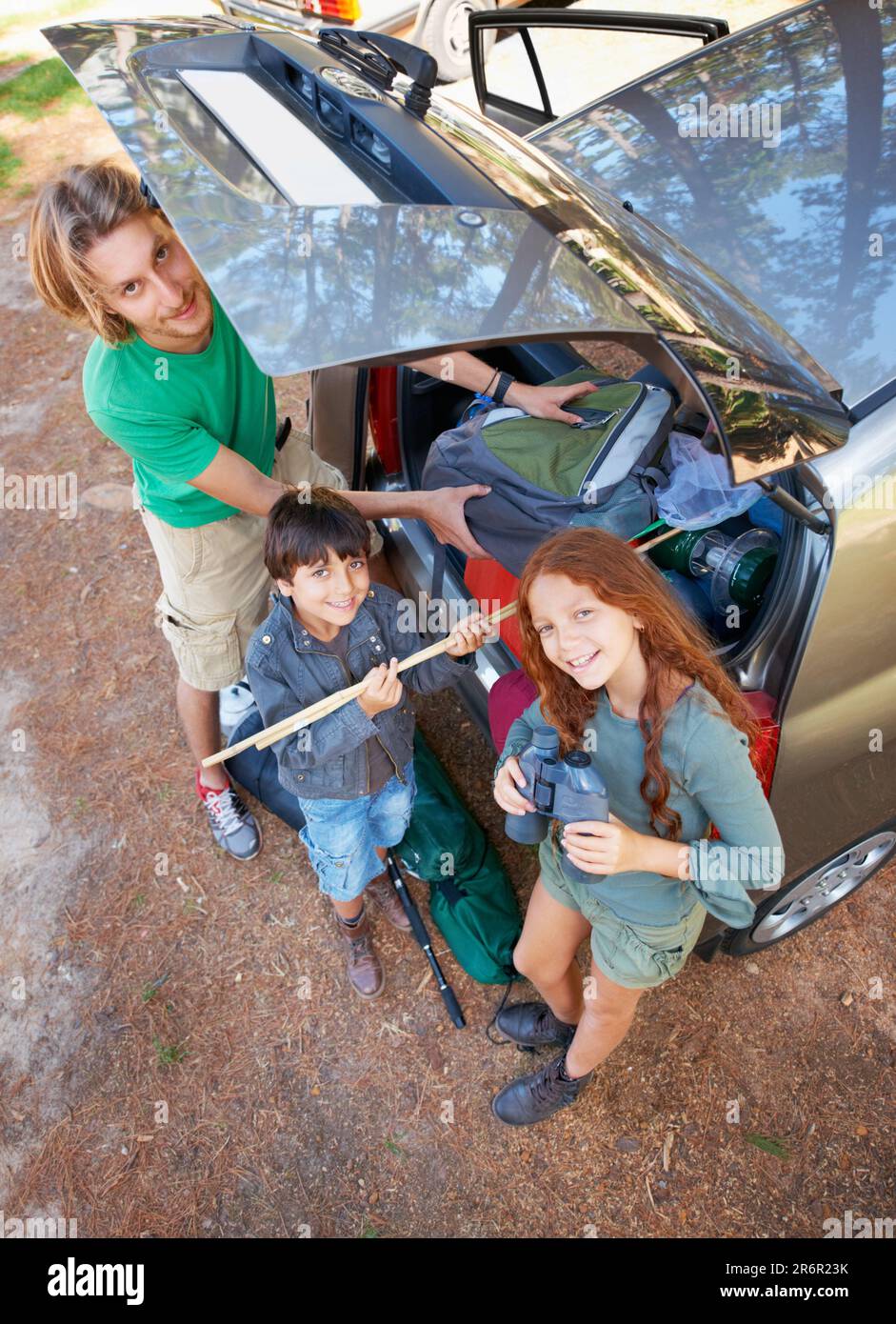 Happy family, portrait and road trip above packing car for camping ...