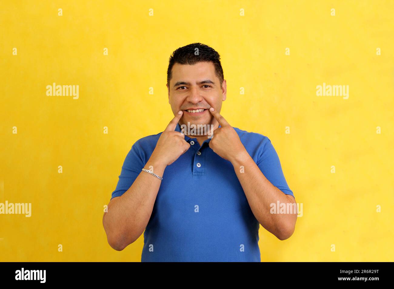Dark-haired 40-year-old Latino man shows Mexican sign language used to ...