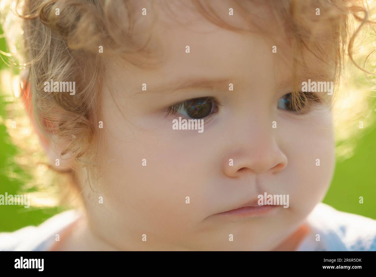 Funny child face close up. Kids baby serious portrait Stock Photo - Alamy