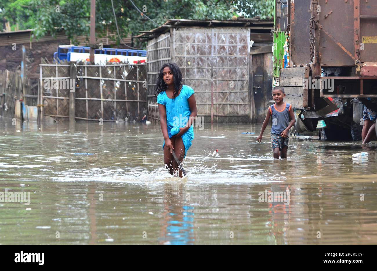 Dimapur, India. 11th June, 2023. Residents wade in a flooded street at ...