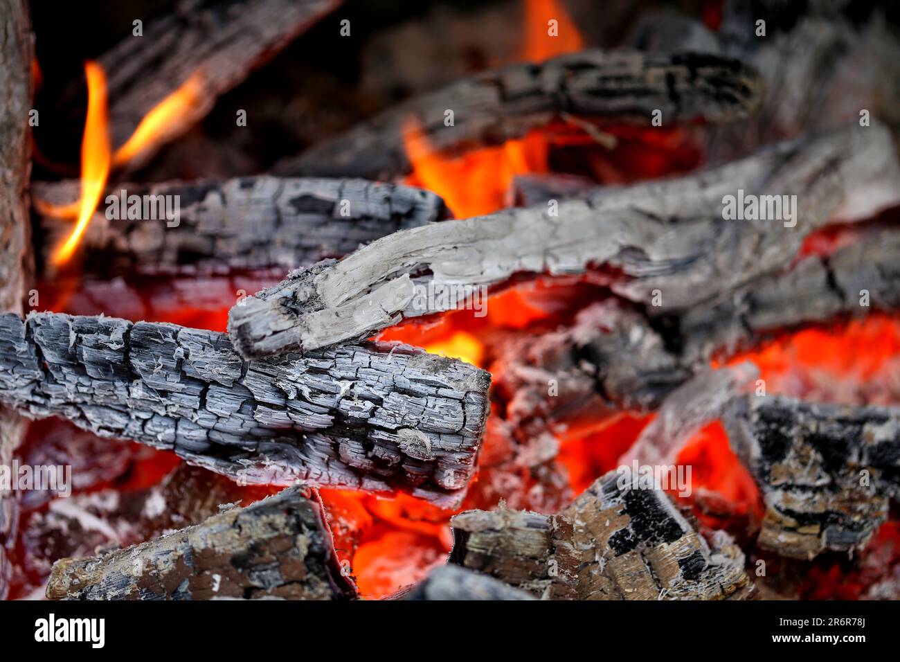Wooden embers close-up on a whole background Stock Photo - Alamy