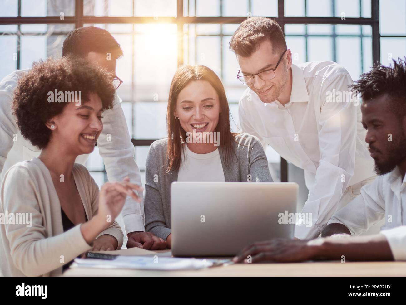 Employees working at computer together, discussing content Stock Photo ...