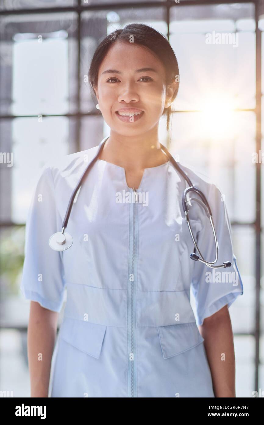 Southeast Asian medical student. Young medical doctor woman standing on ...