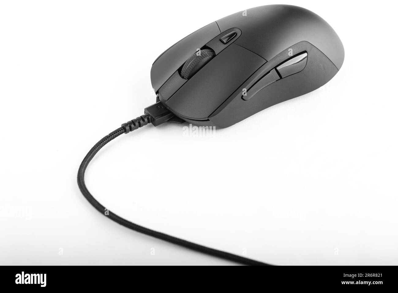Black computer mouse with a wire on a white background. Office ...