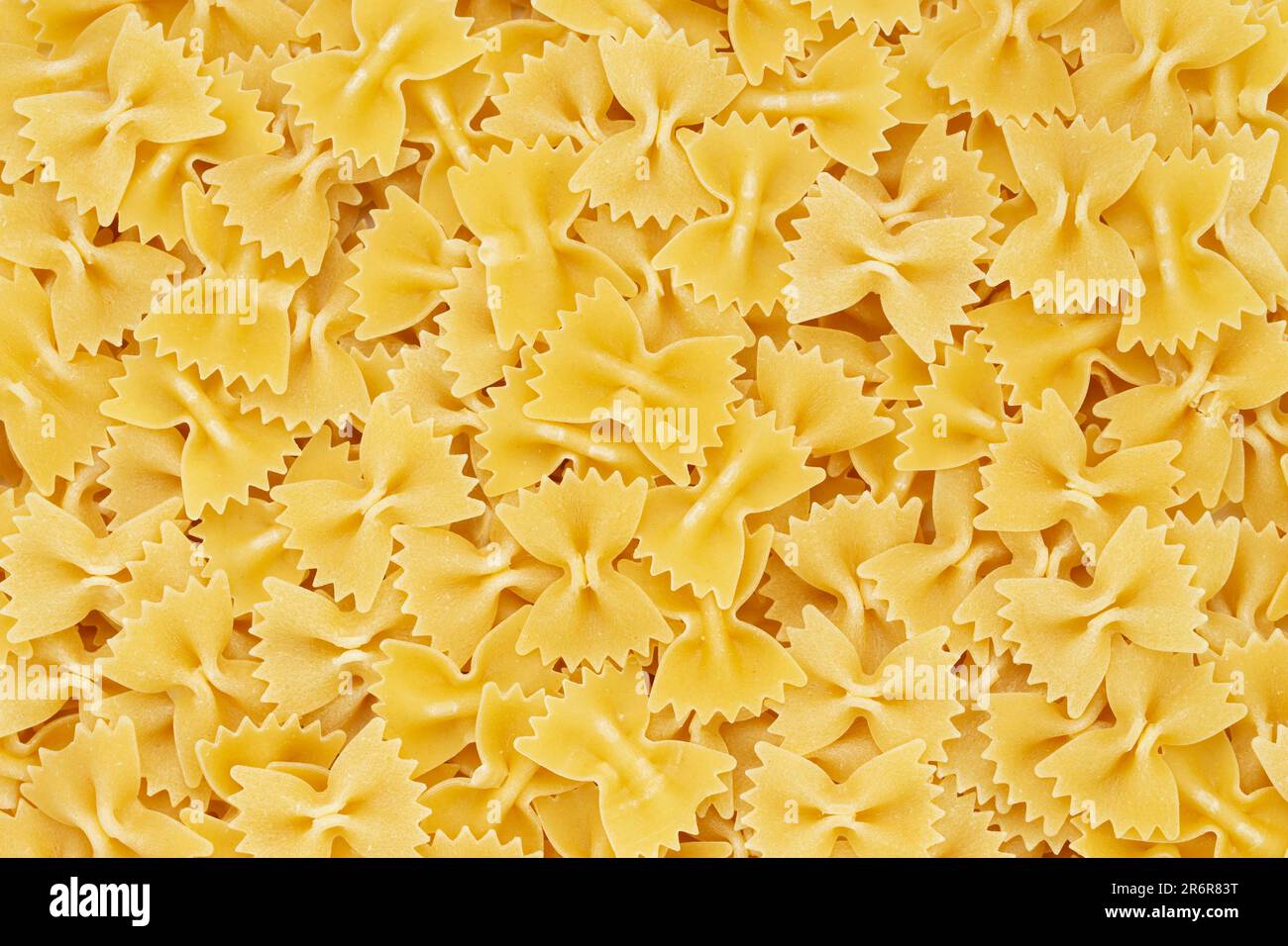 Texture of dry Italian pasta macaroni bows farfalle. Close up ...