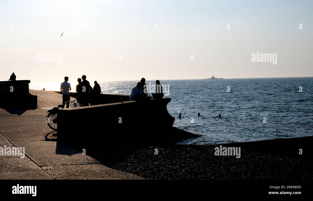 tourists in silhouette, herne bay seaside town, isle of thanet, east ...