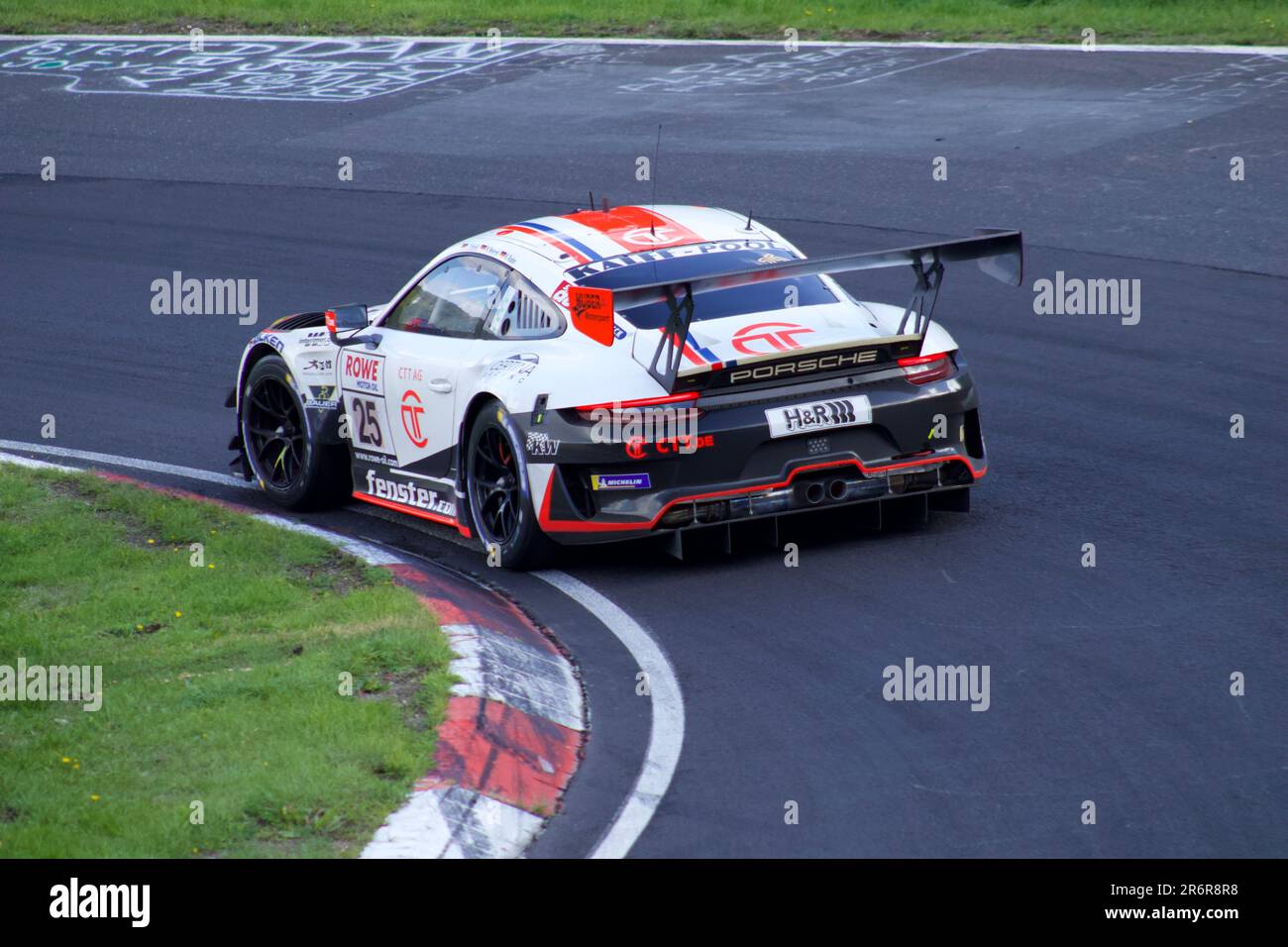 A white race car driving on a track, perfect for any motorsport or ...
