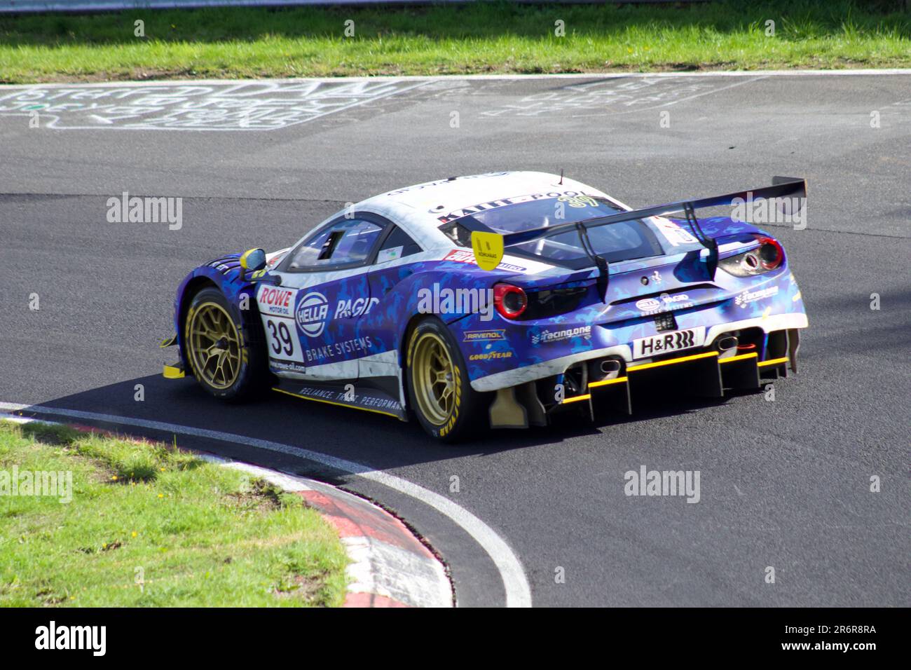 A blue race car driving on a track, perfect for any motorsport or ...