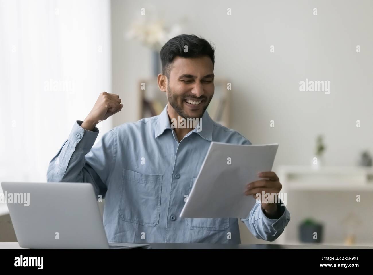 Positive Indian professional man celebrating business success Stock ...