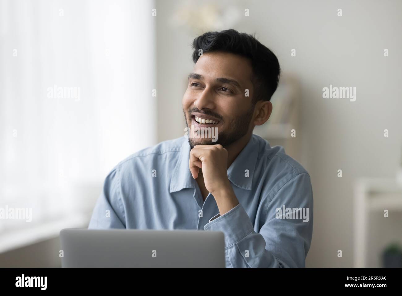 Happy young Indian business professional man thinking at home Stock ...