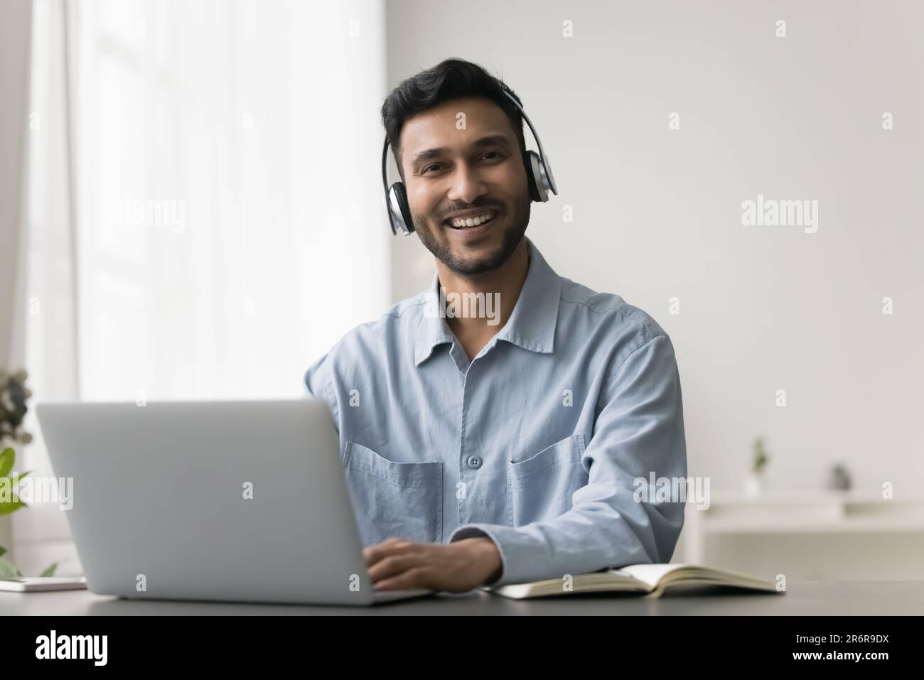 Happy young Indian professional business man, operator, customer ...
