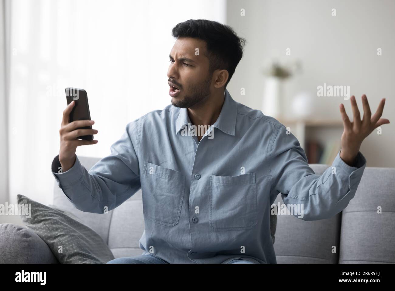 Mad frustrated young Indian guy having problems with online ...