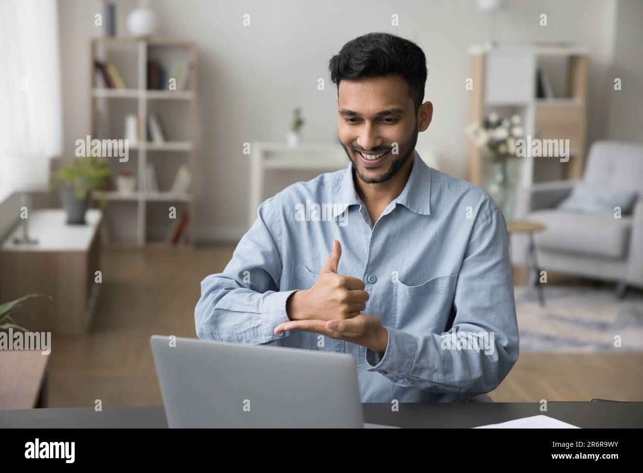 Positive sign language therapist speaking with gestures on video call ...