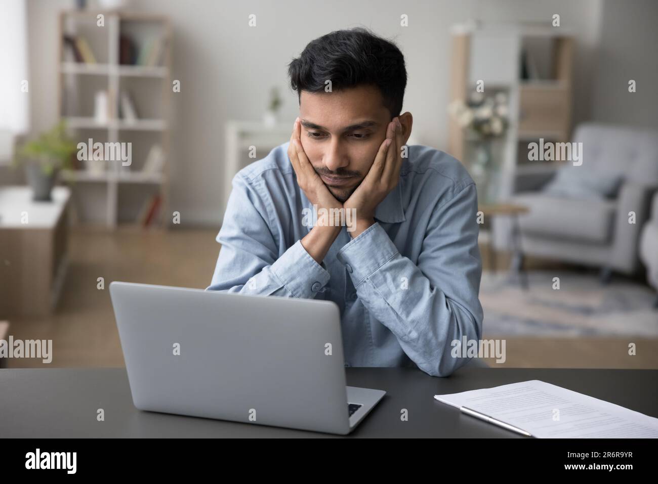 Tired bored freelance employee guy looking at laptop display Stock ...