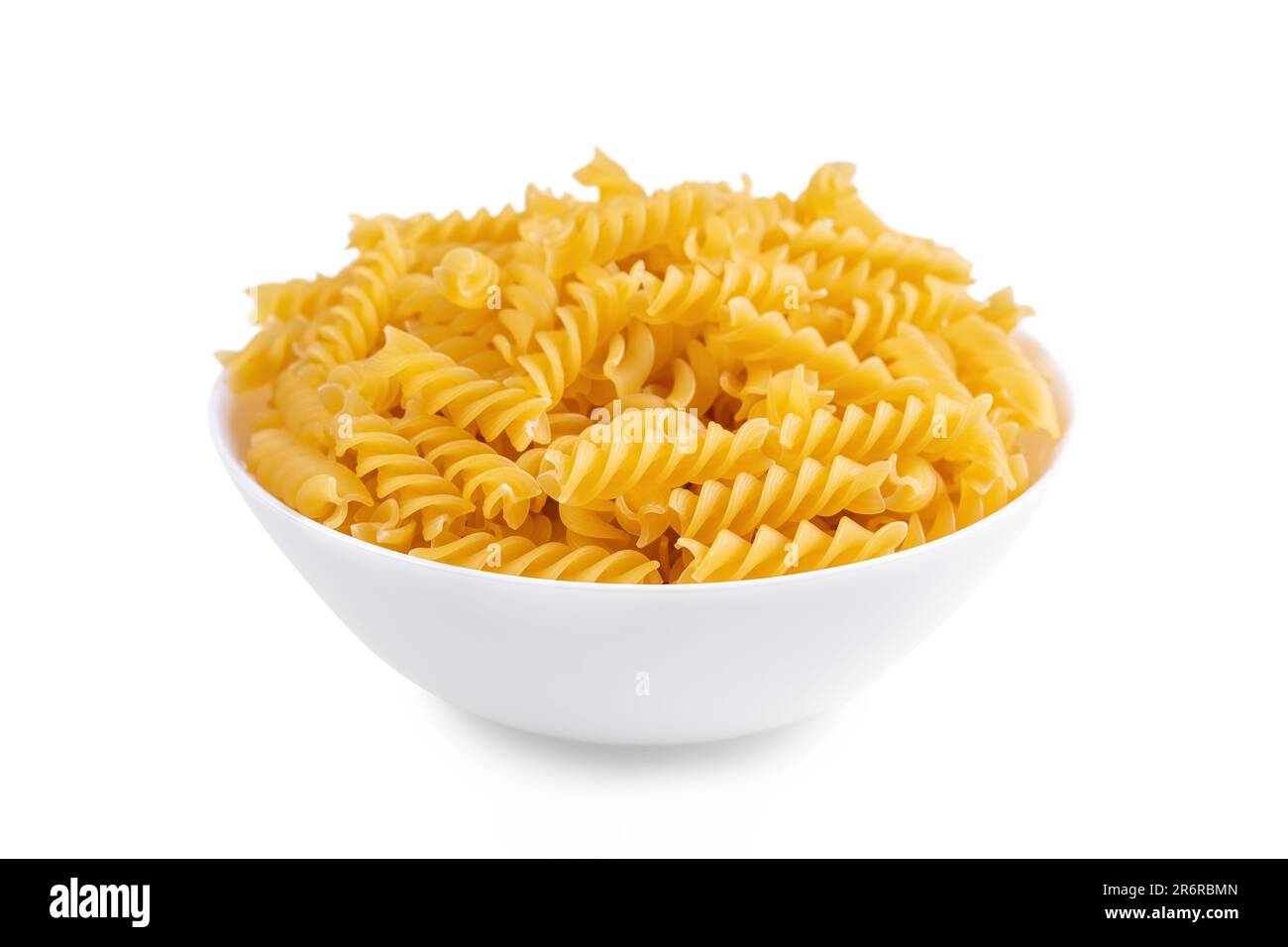 Fusilli In Bowl And Isolated On White Background Raw Pasta Spiral Shape Ingredient For Cook