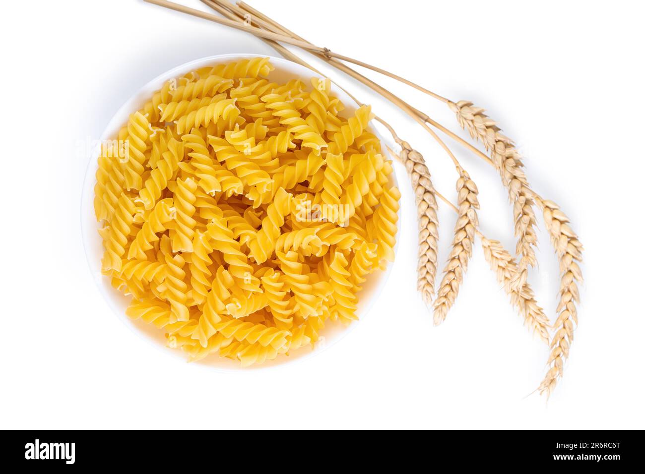Pasta and wheat spikelets isolated on white background. Raw pasta ...